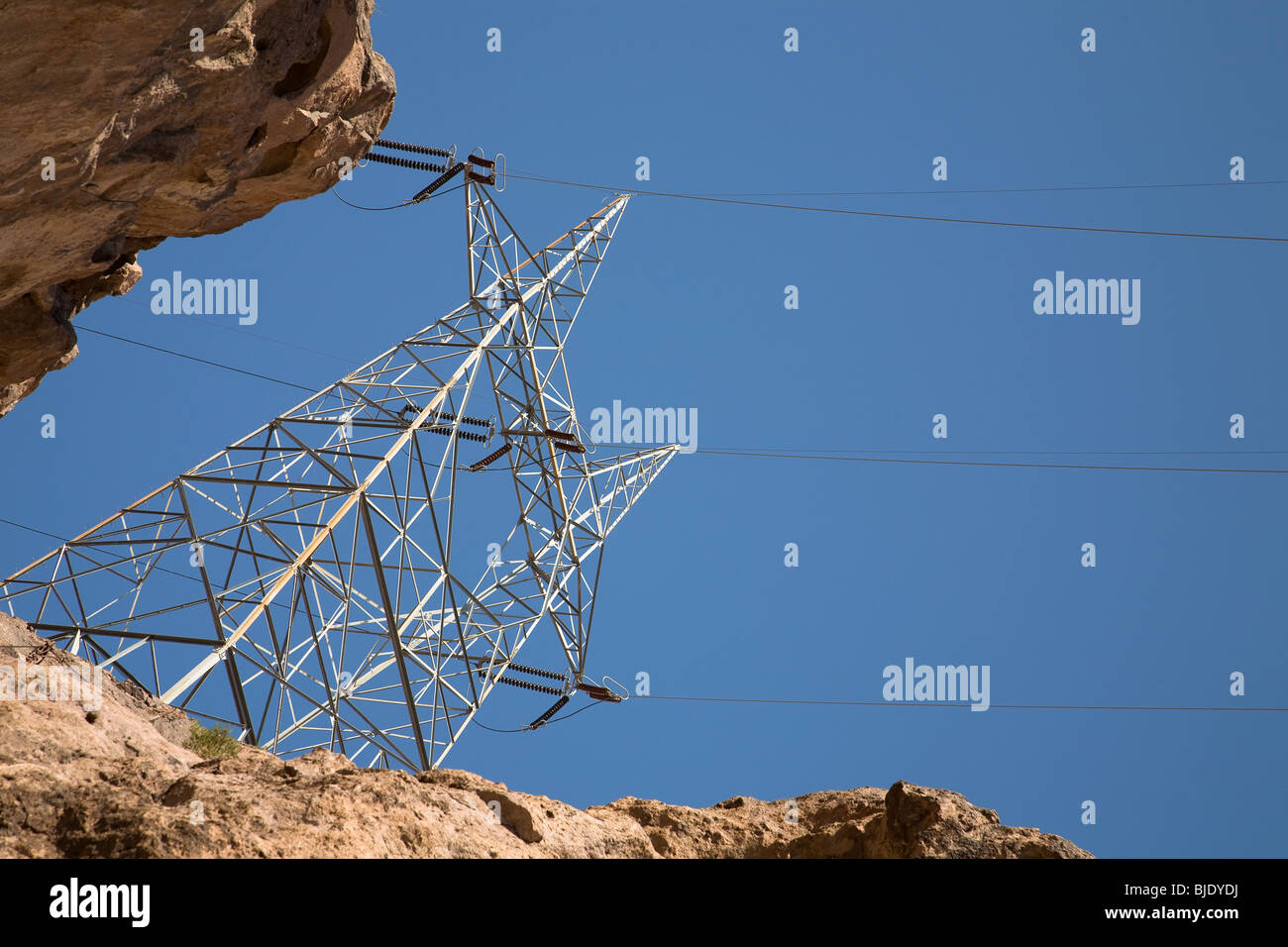 Power cables or lines on a rock against a blue sky background Stock ...