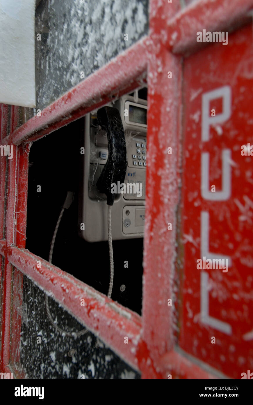 Phone in pay phone box, covered in frost Stock Photo - Alamy