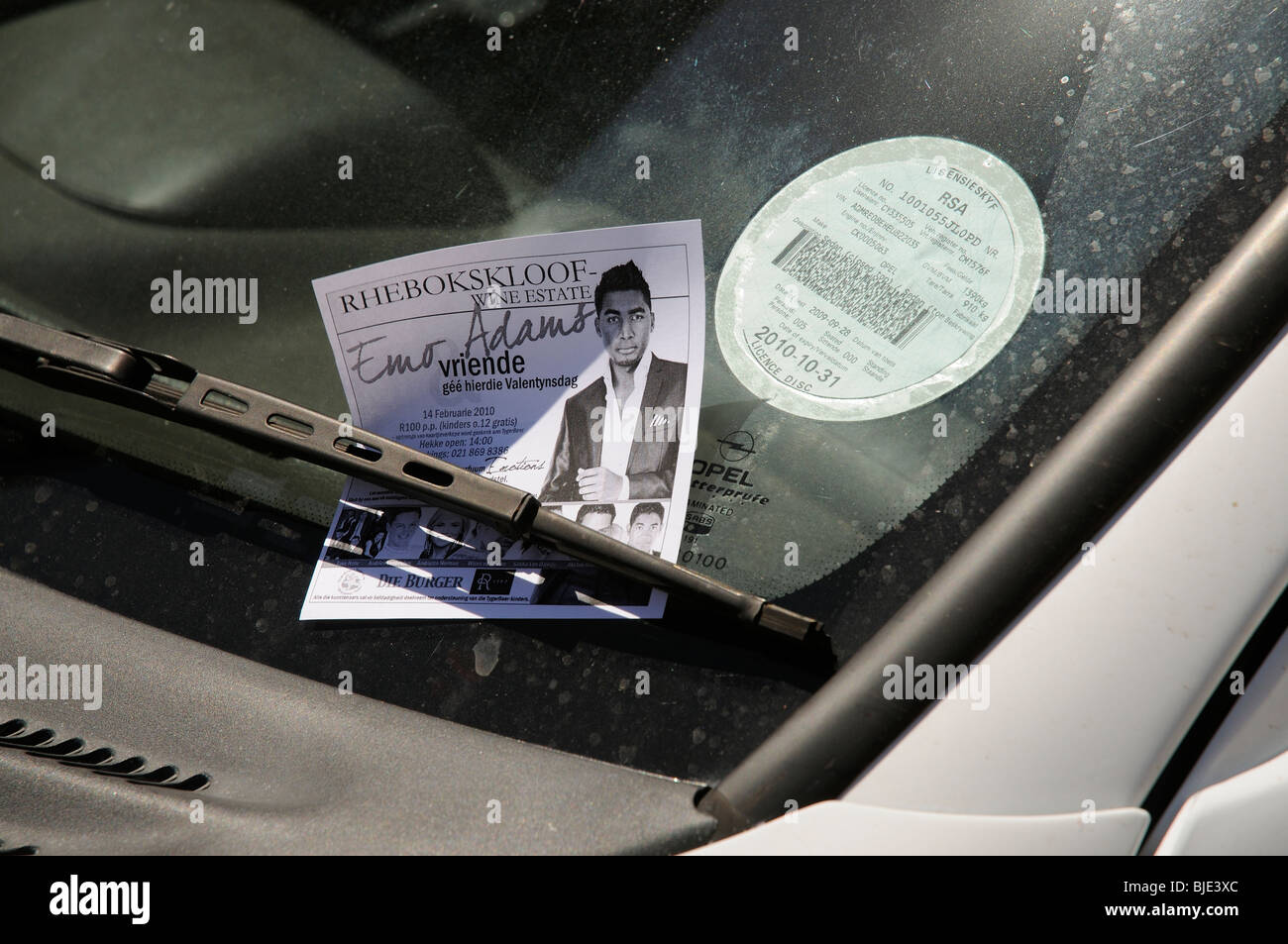 Fly posting unwanted advertising material under windscreen wiper of a ...