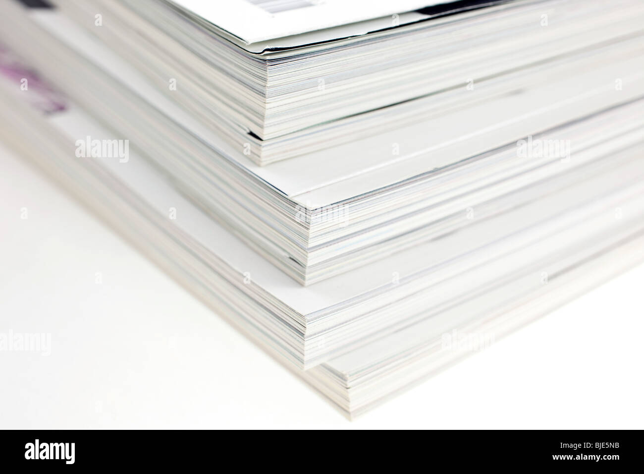 Stacked magazines on white background. Closeup shot Stock Photo - Alamy