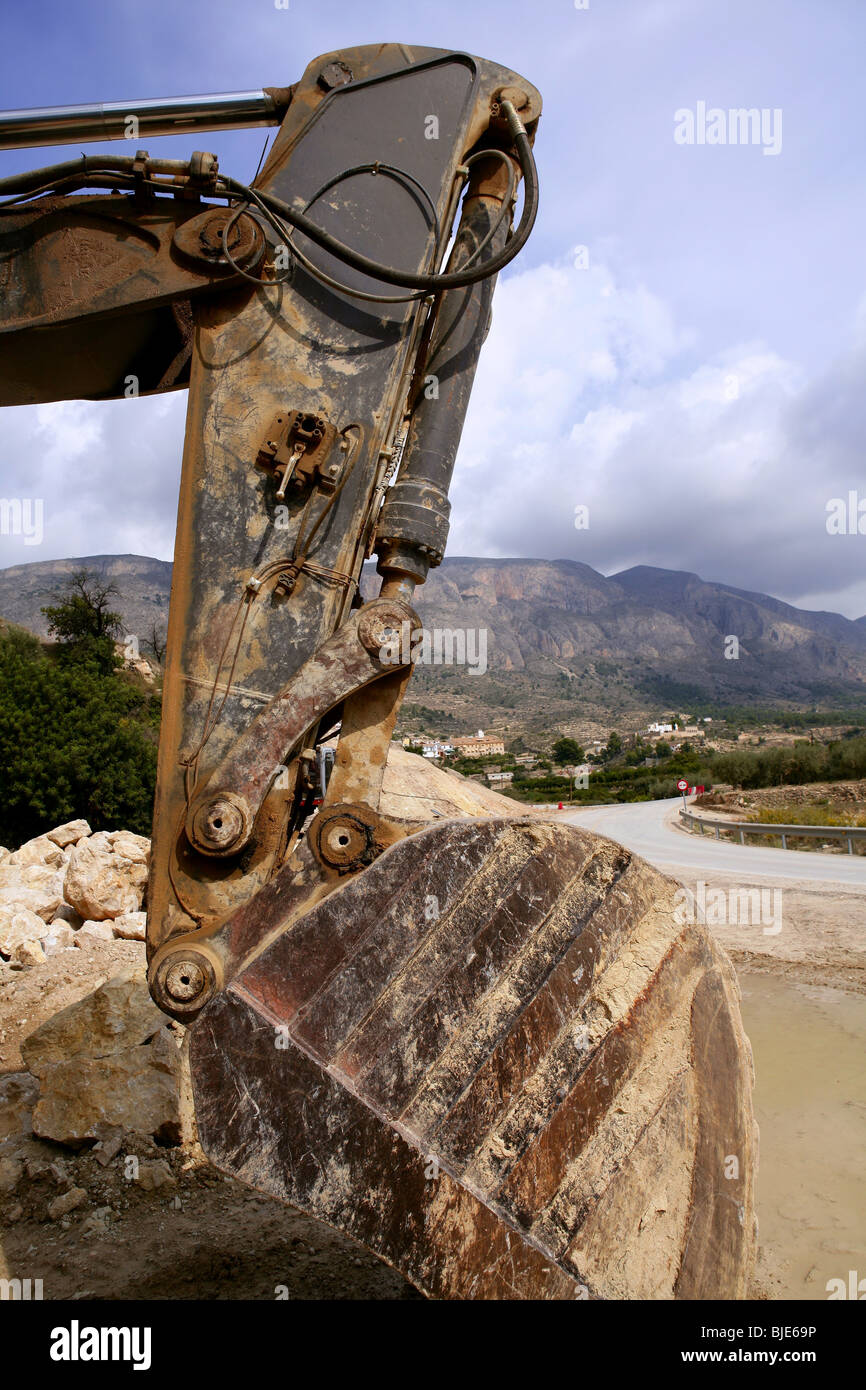 Backhoe bulldozer working hard with stones Stock Photo - Alamy