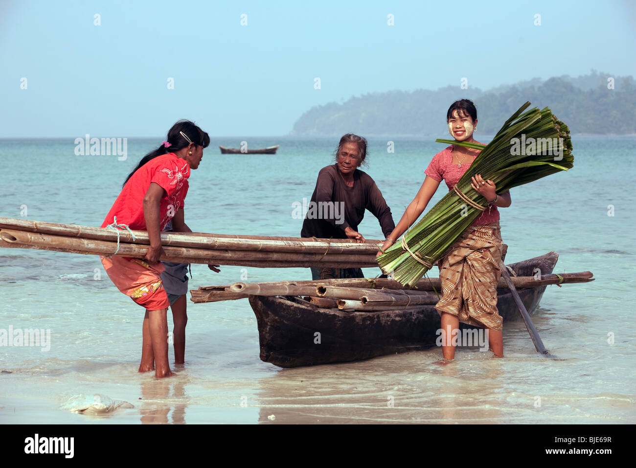 An old Moken lady transporting her wares, one of the sea-gypsies, the ...