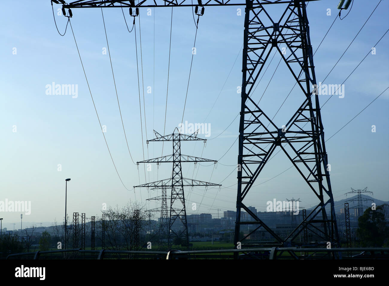 Electric pole towers backlight sky background Stock Photo - Alamy