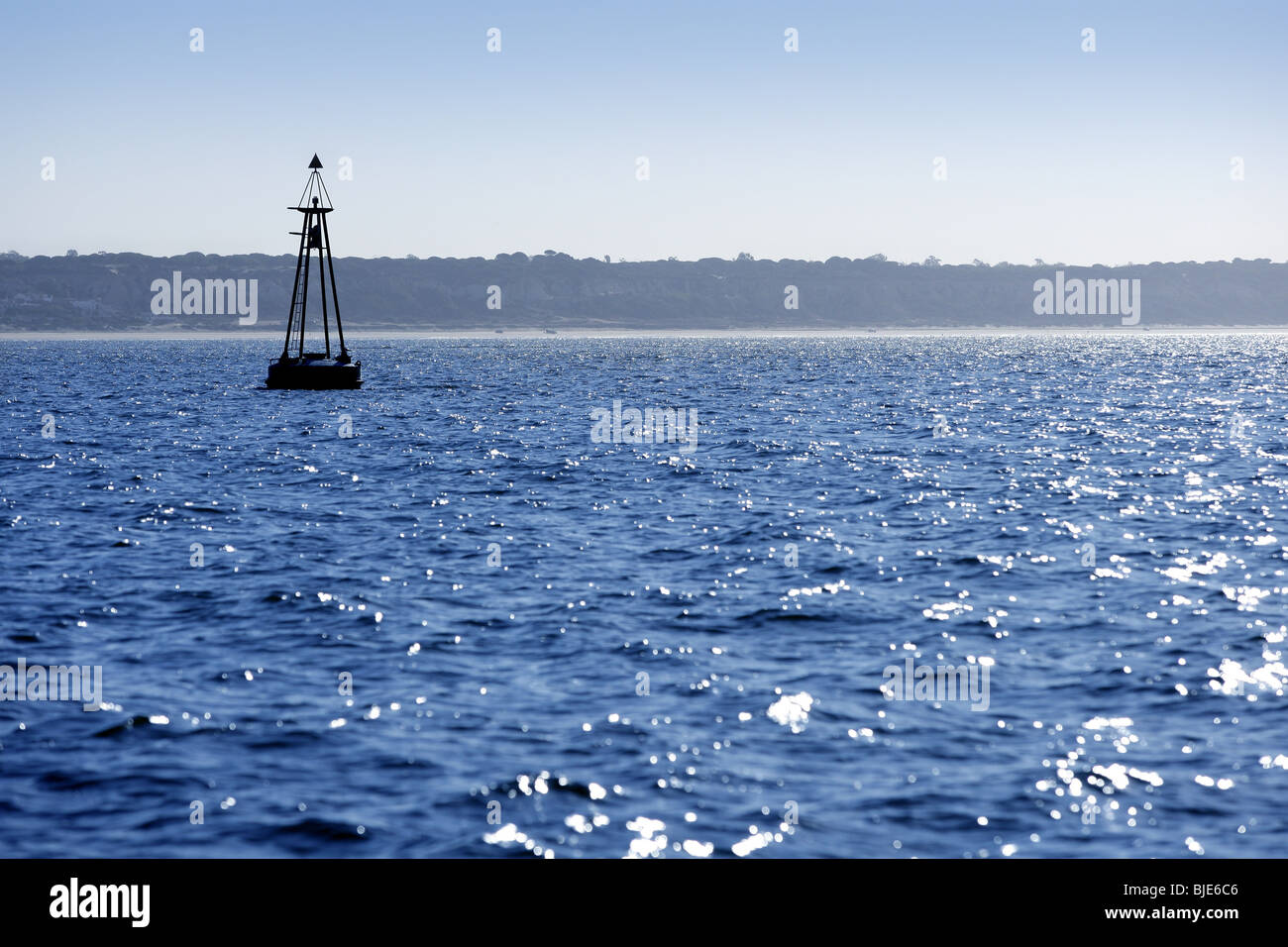 Beacon floating on blue ocean as navigation guide help Stock Photo - Alamy