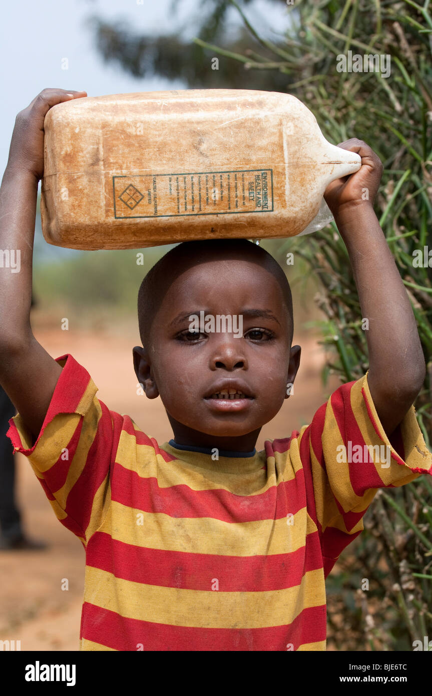Children collecting water from well and carrying home Stock Photo - Alamy