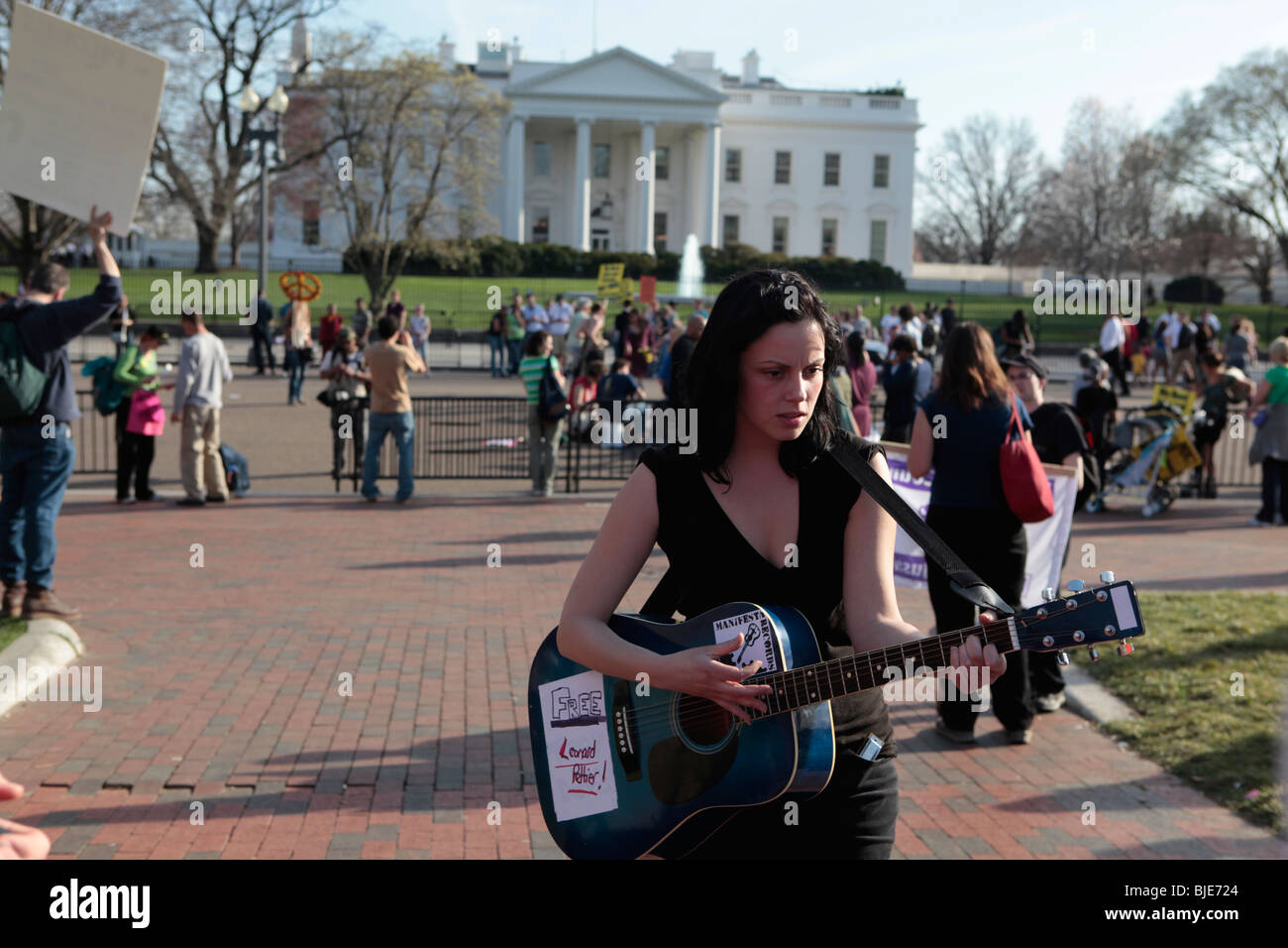 Woman singing folk punk anti war protest songs in front of white house ...