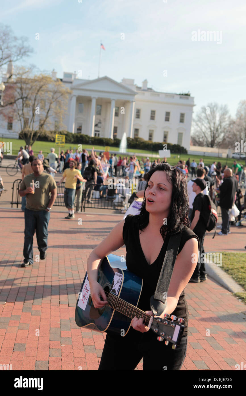 Woman singing folk punk anti war protest songs in front of white house ...
