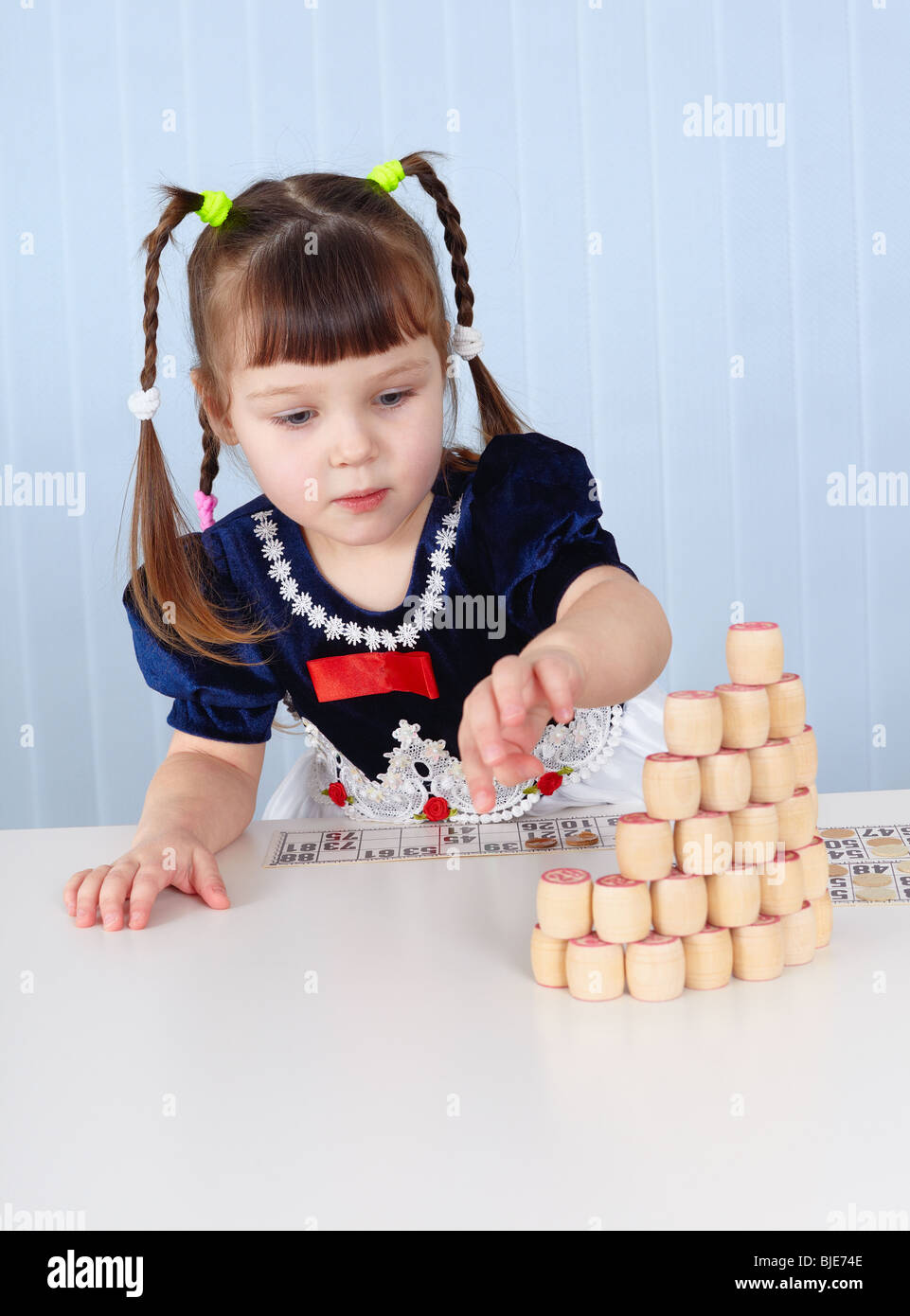 Preschool-age girl playing with wooden Lotto Stock Photo - Alamy