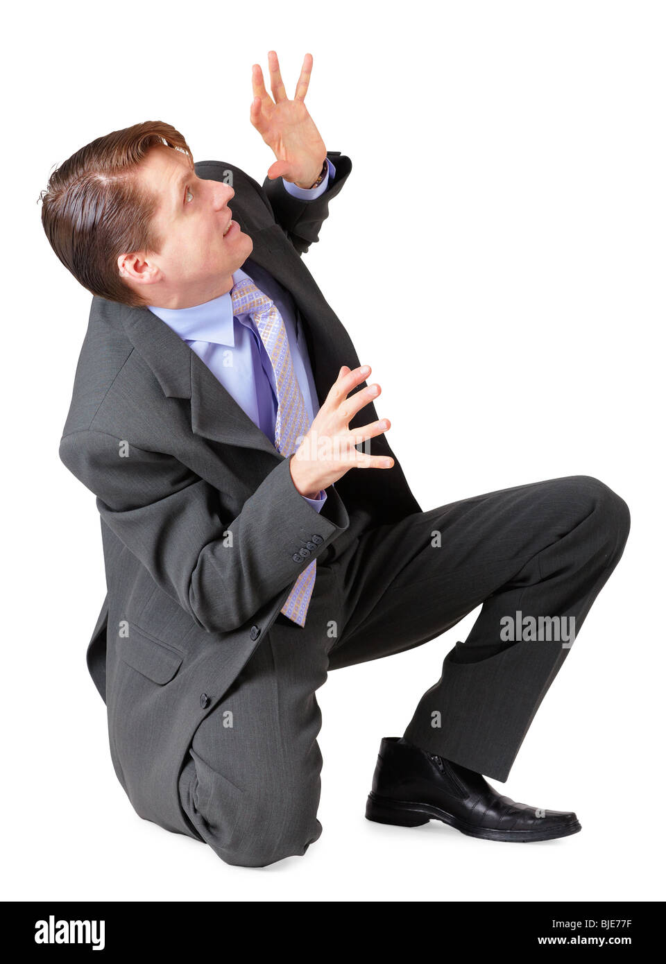 A young man scared and sat on a white background Stock Photo - Alamy