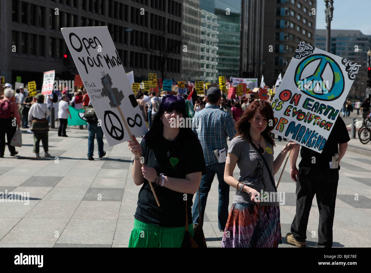 Two young women peace activists carrying signs. Anti-war protest. March ...