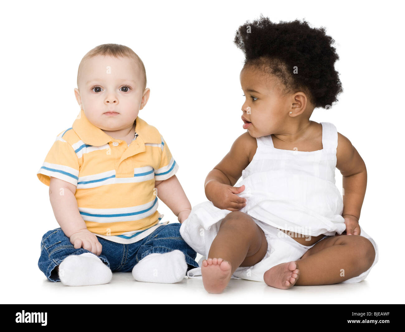 Two babies sitting Stock Photo - Alamy
