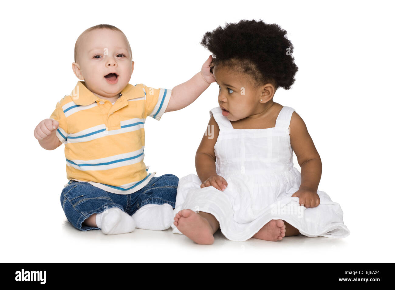 Two babies sitting Stock Photo - Alamy