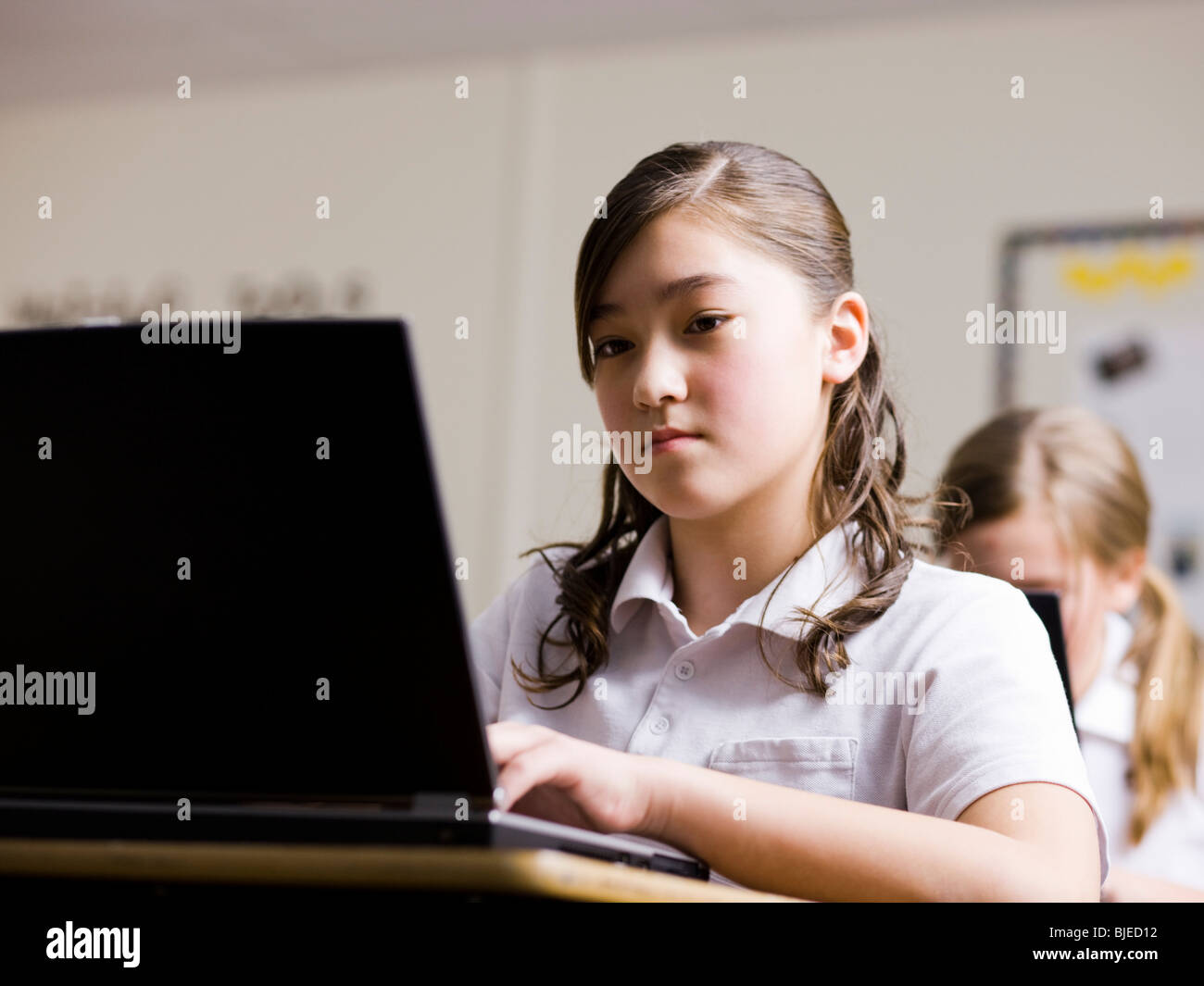 girl with laptop in classroom Stock Photo - Alamy