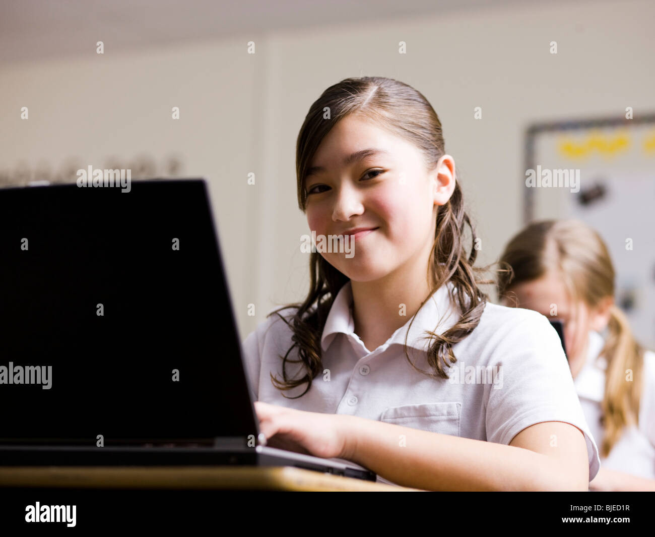 girl with laptop in classroom Stock Photo - Alamy