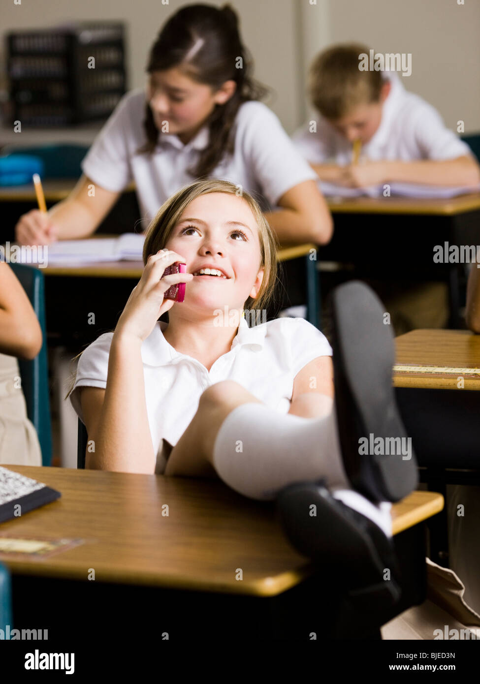 girl talking on phone in classroom Stock Photo - Alamy