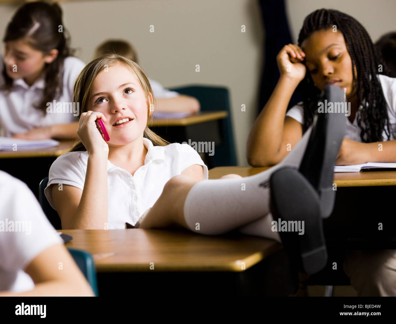 girl talking on phone in classroom Stock Photo - Alamy