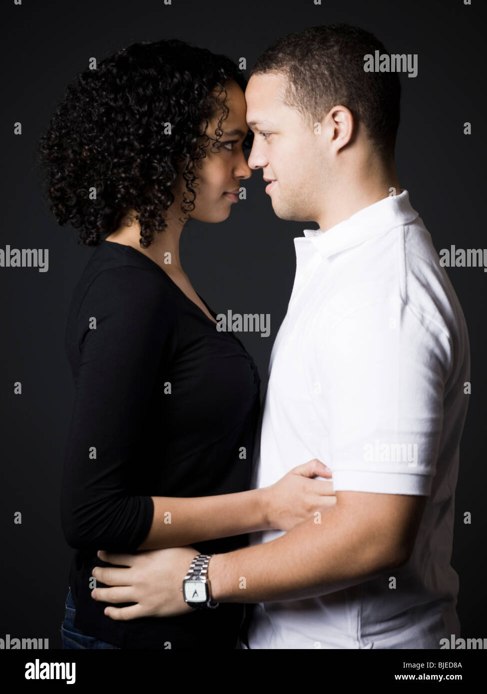 Studio mixed race couple kissing hi-res stock photography and images ...