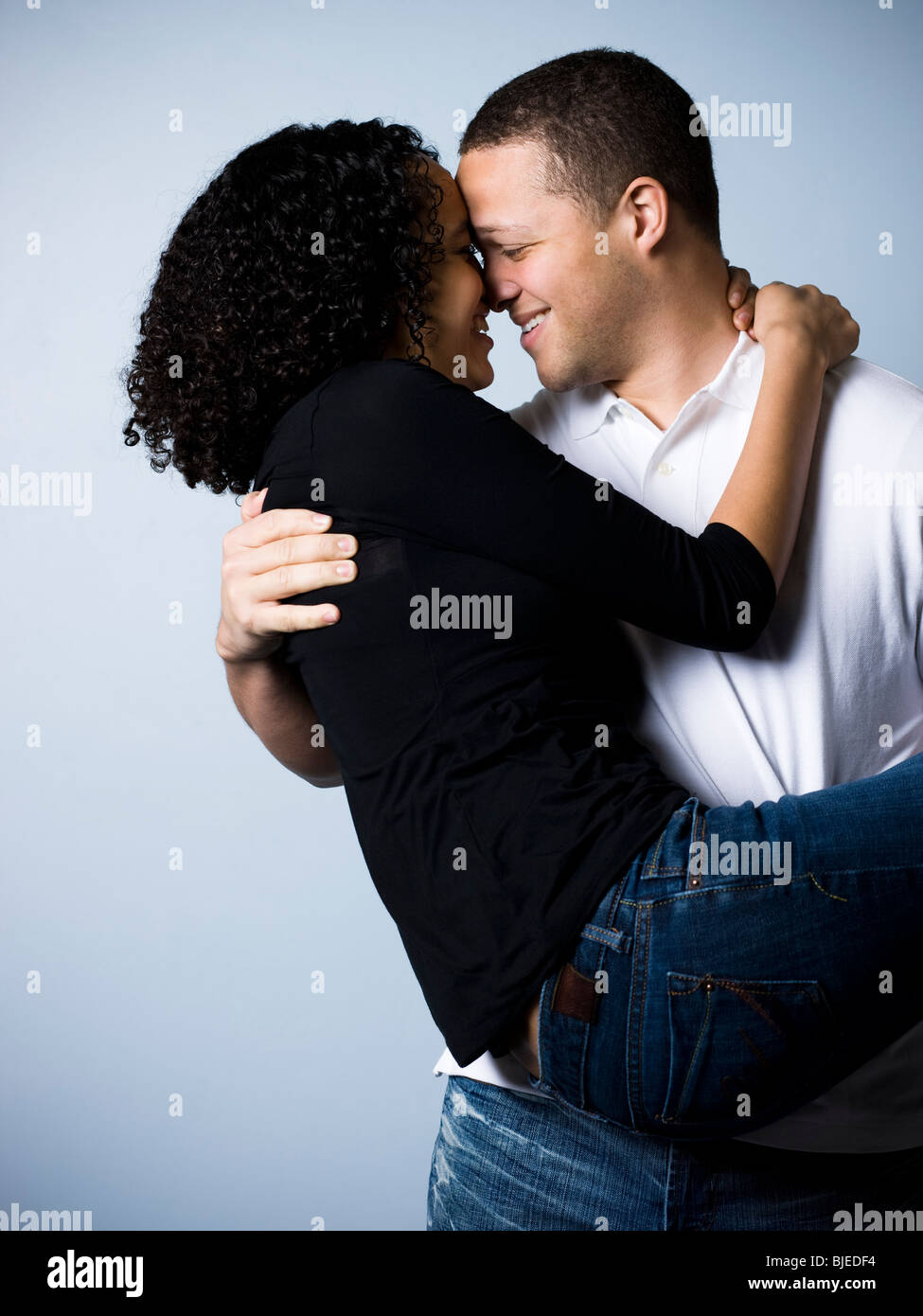 Studio mixed race couple kissing hi-res stock photography and images ...