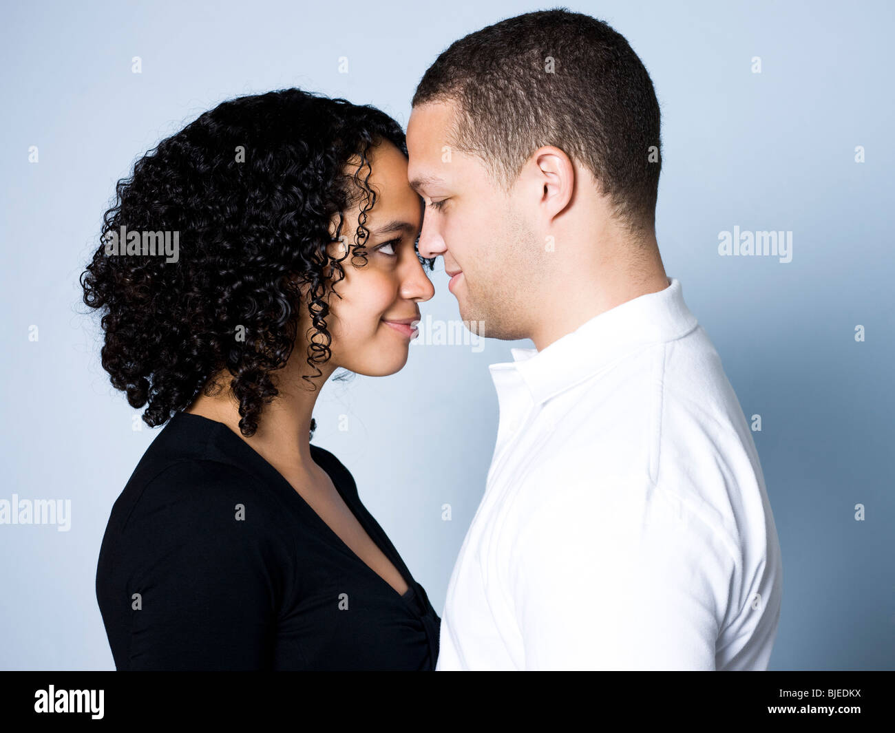 Studio mixed race couple kissing hi-res stock photography and images ...