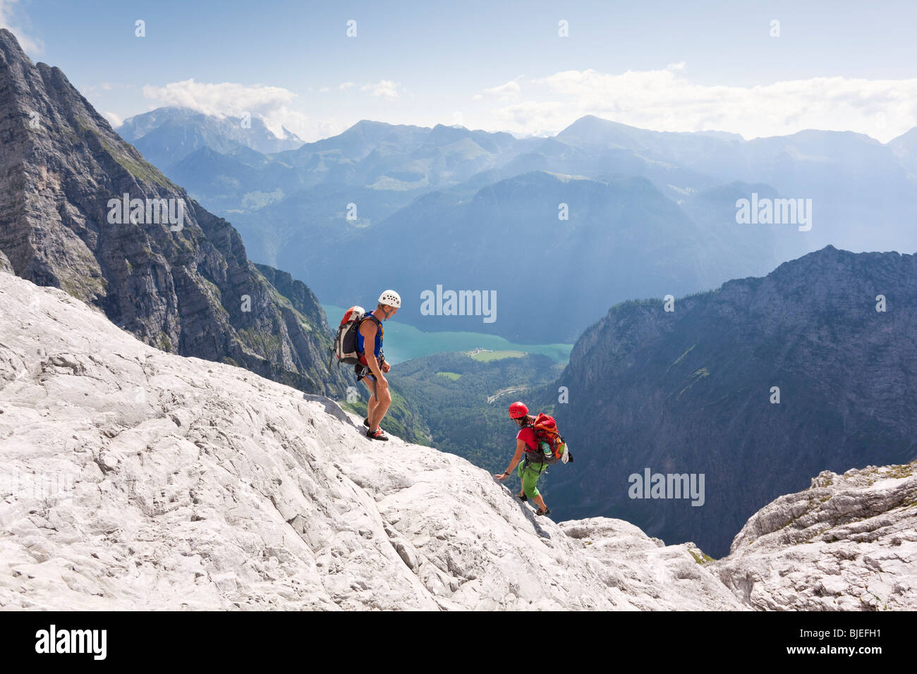 Couple on a rock in the Berchtesgaden Alps, Konig lake in the ...