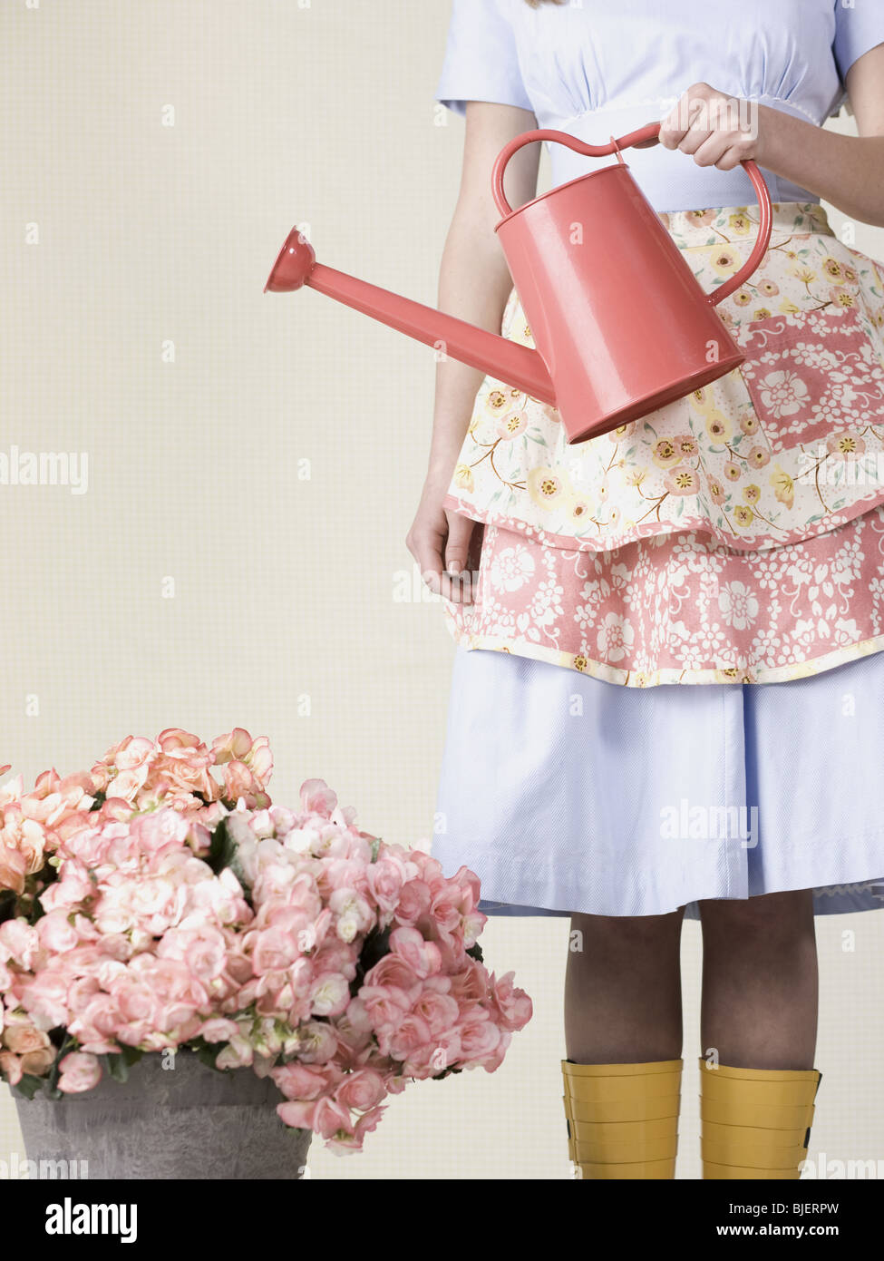 woman with a watering can Stock Photo - Alamy