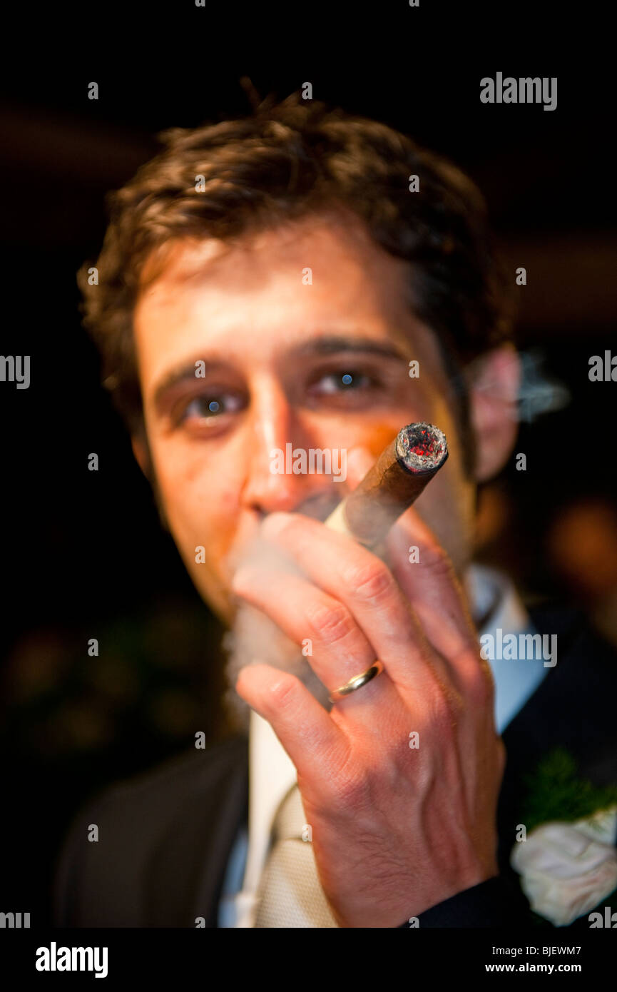 Groom smoking cigar Stock Photo - Alamy