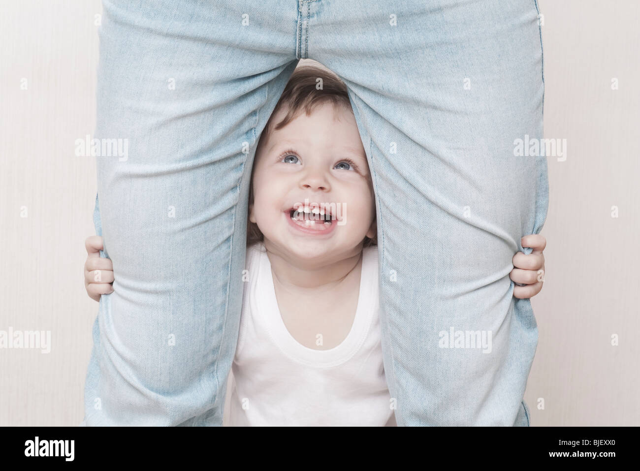 Child holding onto mothers legs hi-res stock photography and images - Alamy