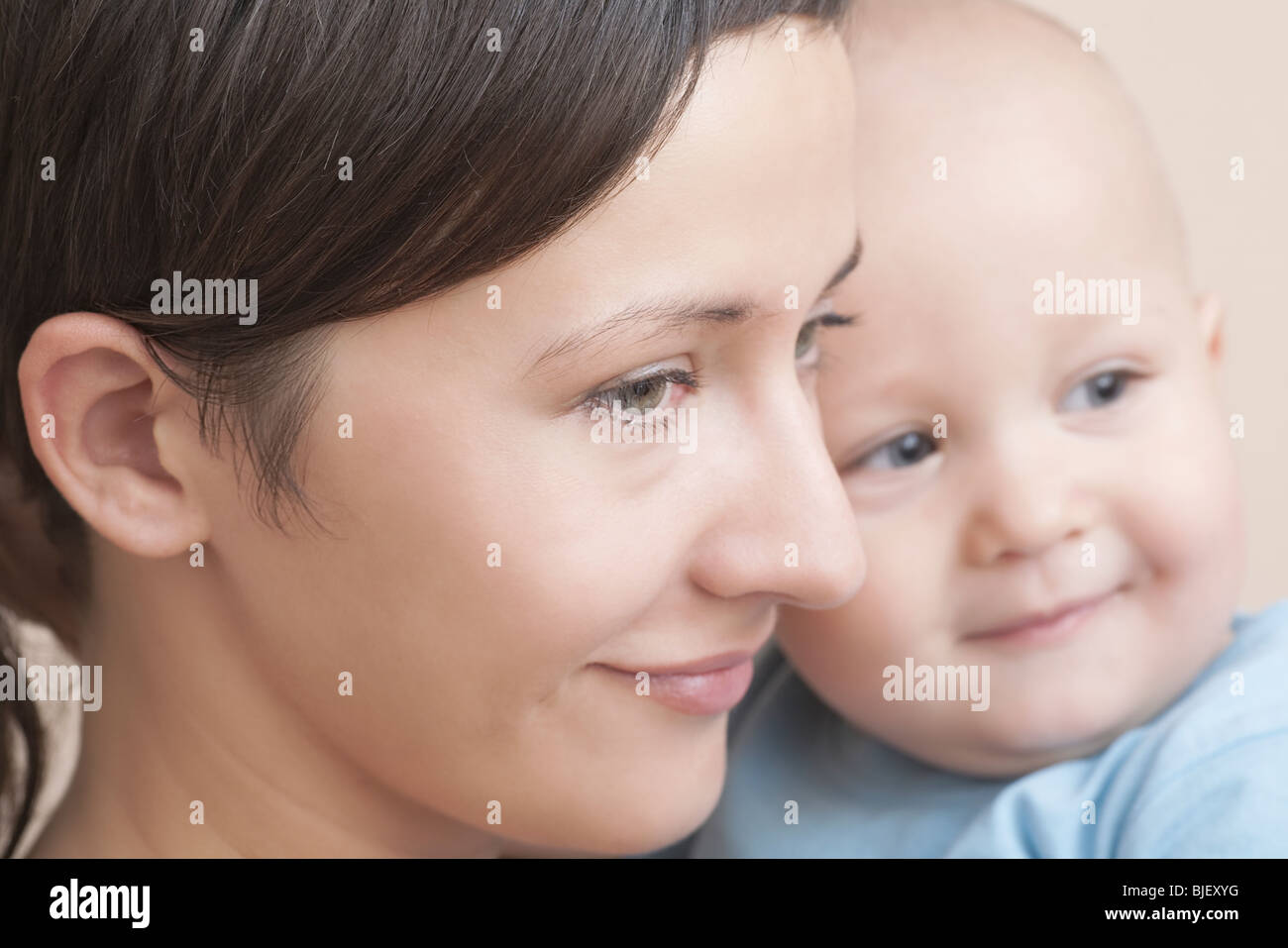Mother smiles holding baby Stock Photo - Alamy
