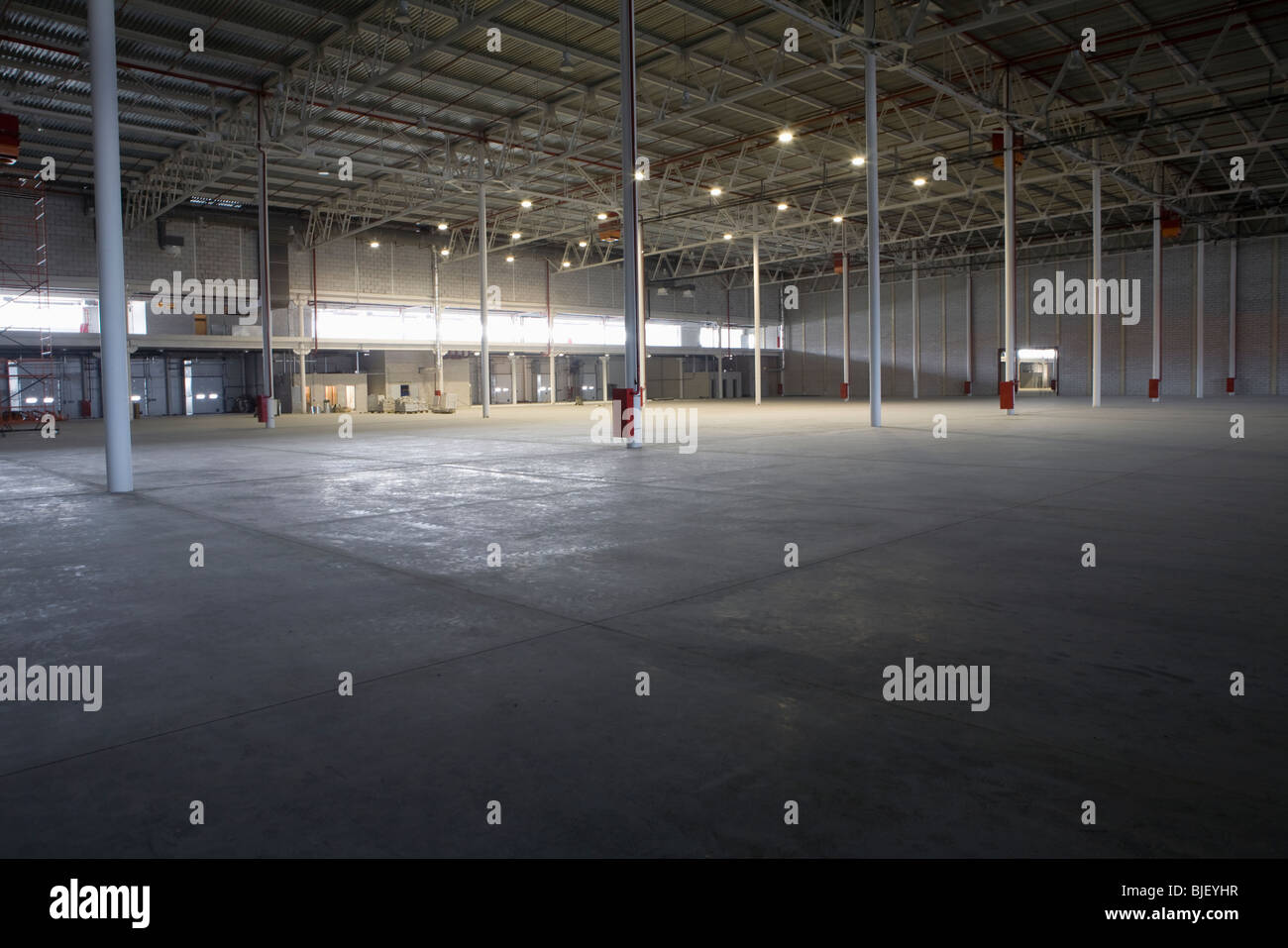 Empty industrial warehouse interior with concrete flooring hi-res stock ...