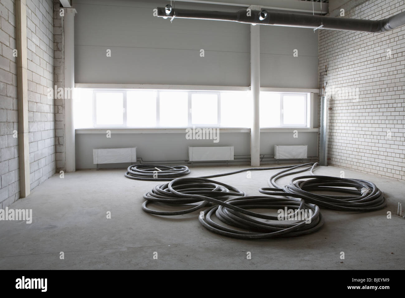Cable wires in empty room, warehouse Stock Photo - Alamy