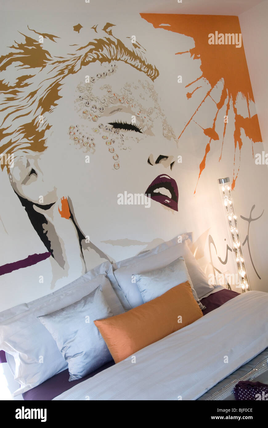 Large mural of female face on a bedroom wall Stock Photo - Alamy