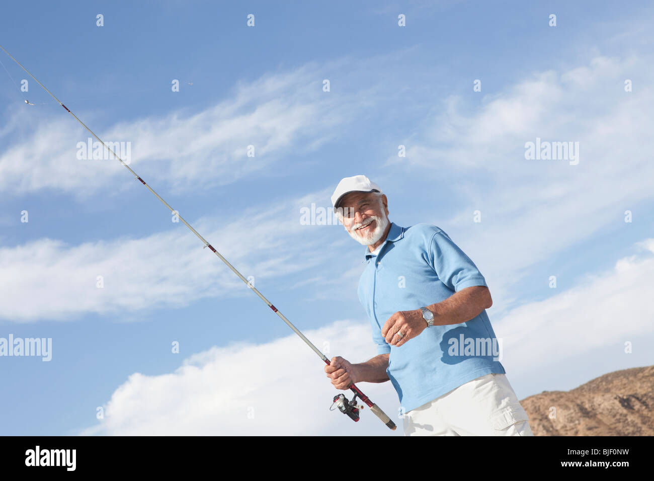 Senior man fishing Stock Photo - Alamy