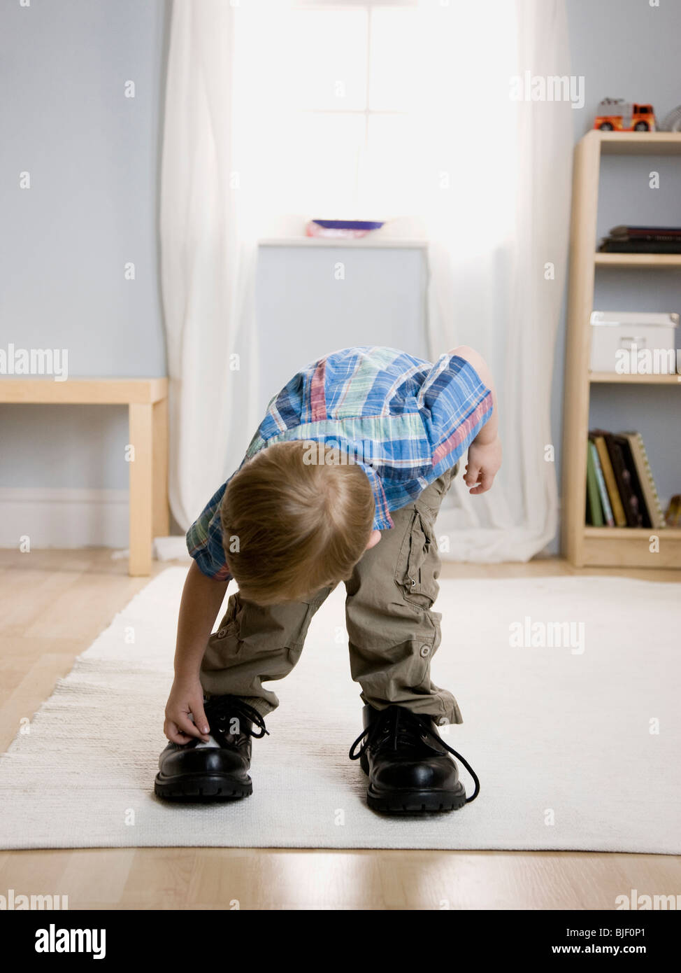 little boy wearing a man's shoes Stock Photo - Alamy