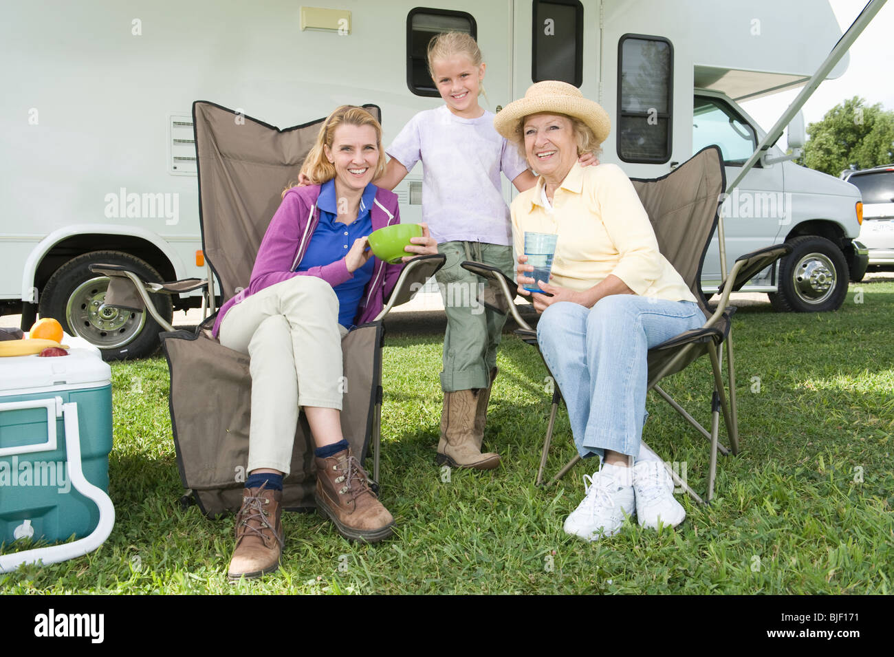 Mother, daughter and grand daughter sit outside RV home Stock Photo - Alamy