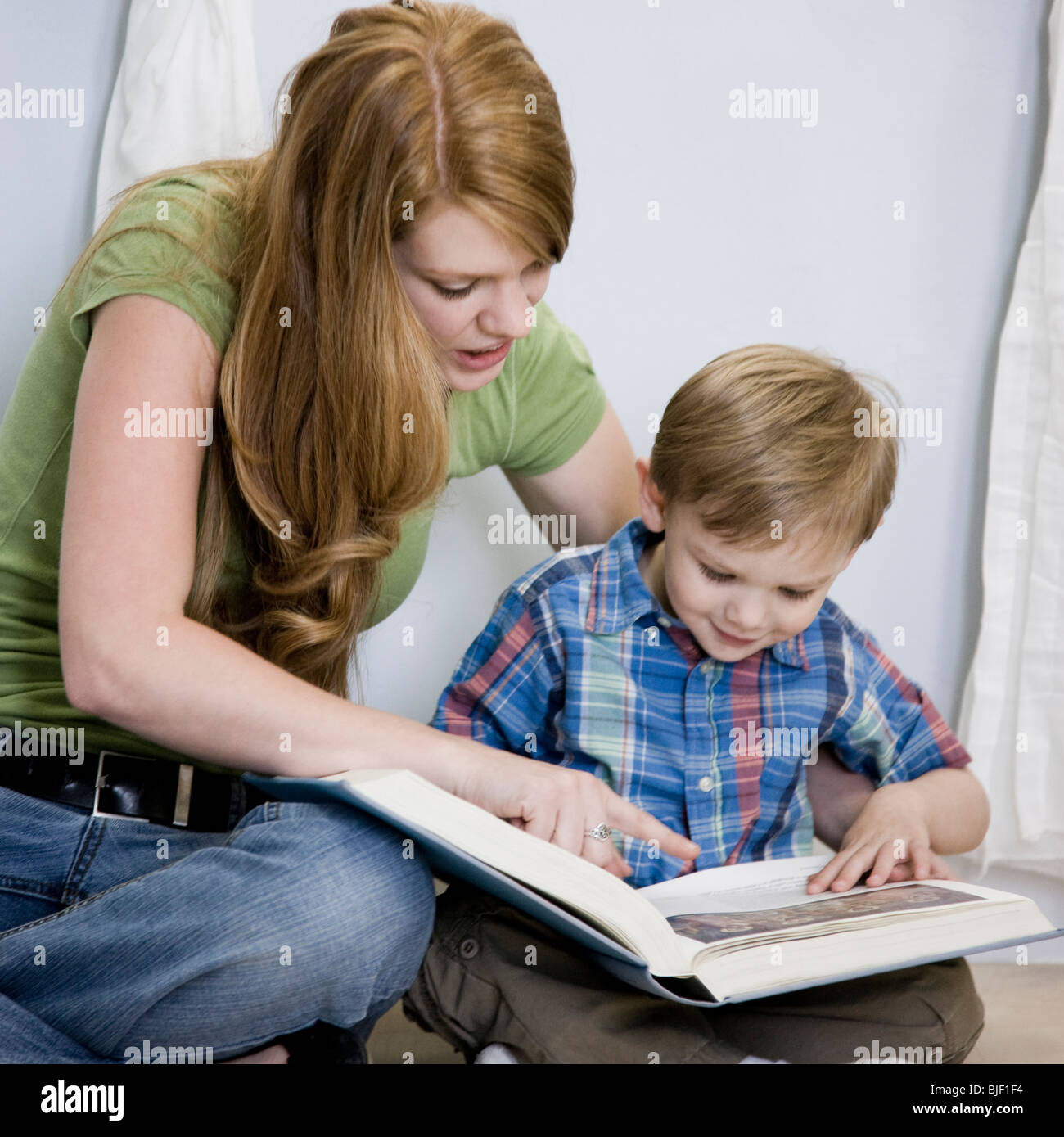 mother reading with child Stock Photo - Alamy
