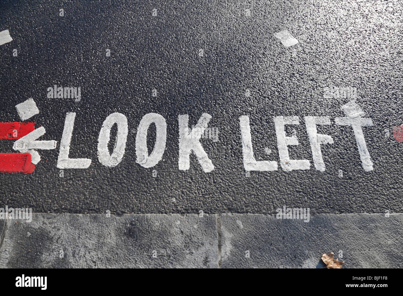 A 'Look Left' sign for pedestrians on the road in London UK Stock Photo ...