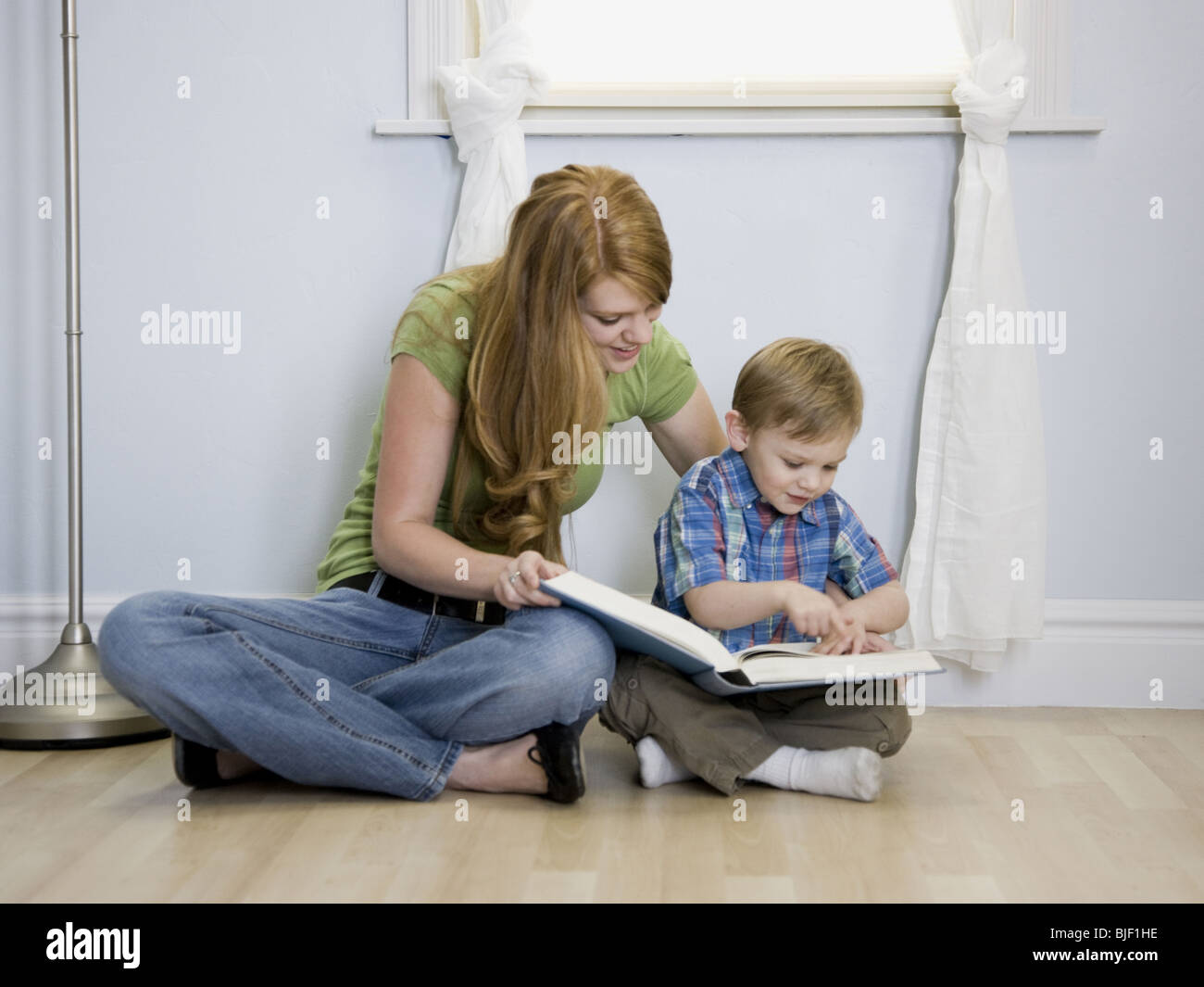 mother reading with child Stock Photo - Alamy