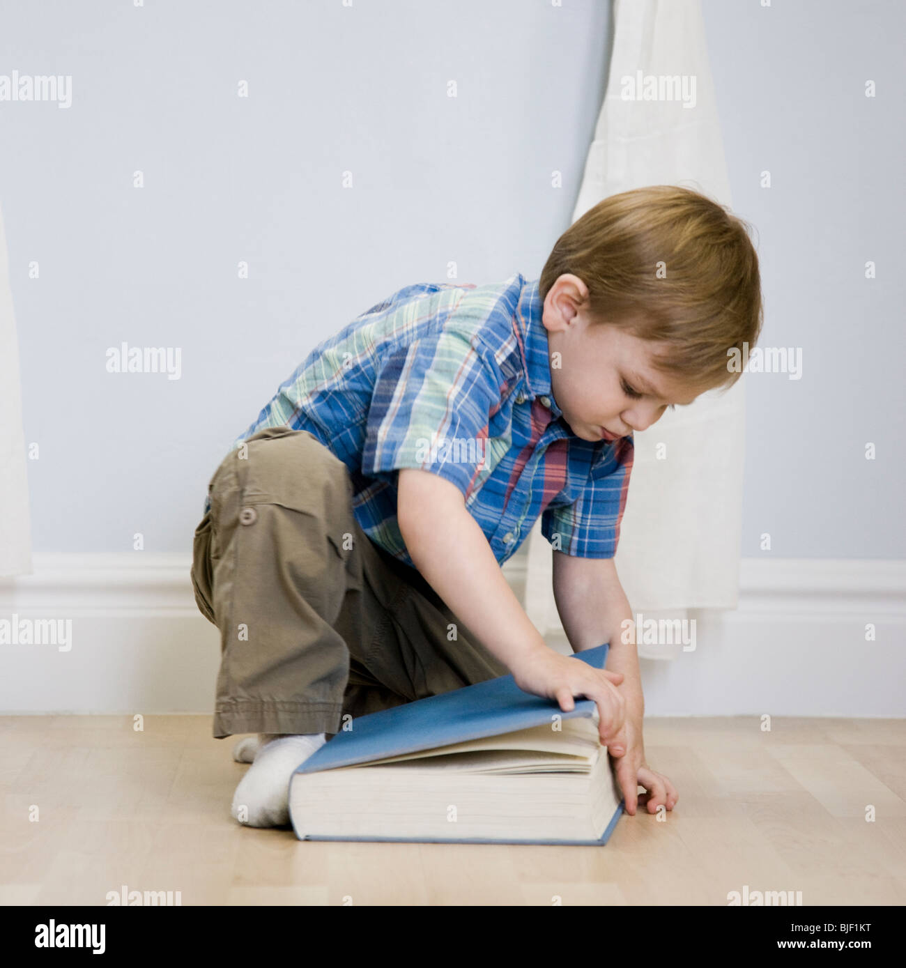 little boy opening a book Stock Photo - Alamy