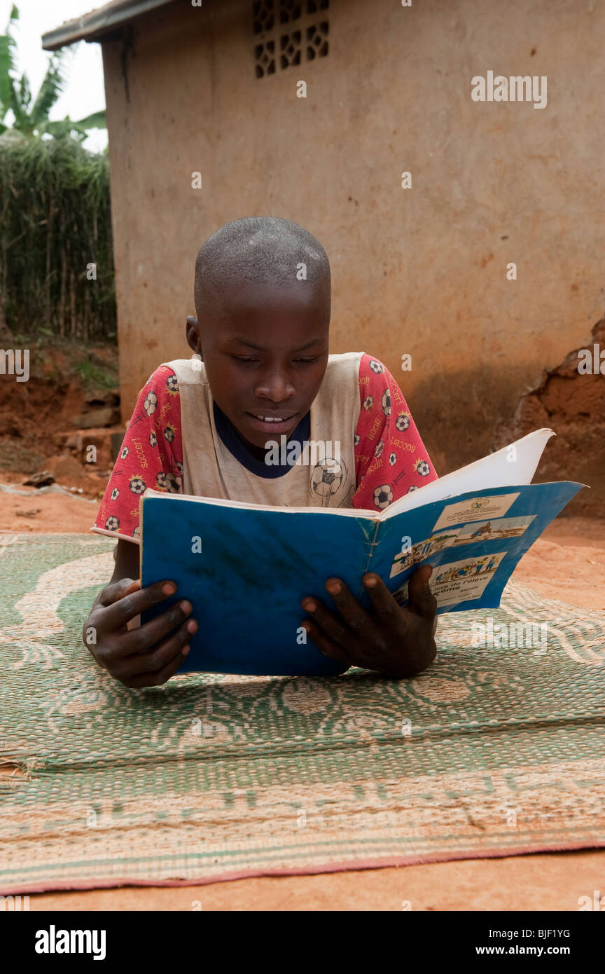 Child reading from educational book at home. Rwanda Stock Photo - Alamy