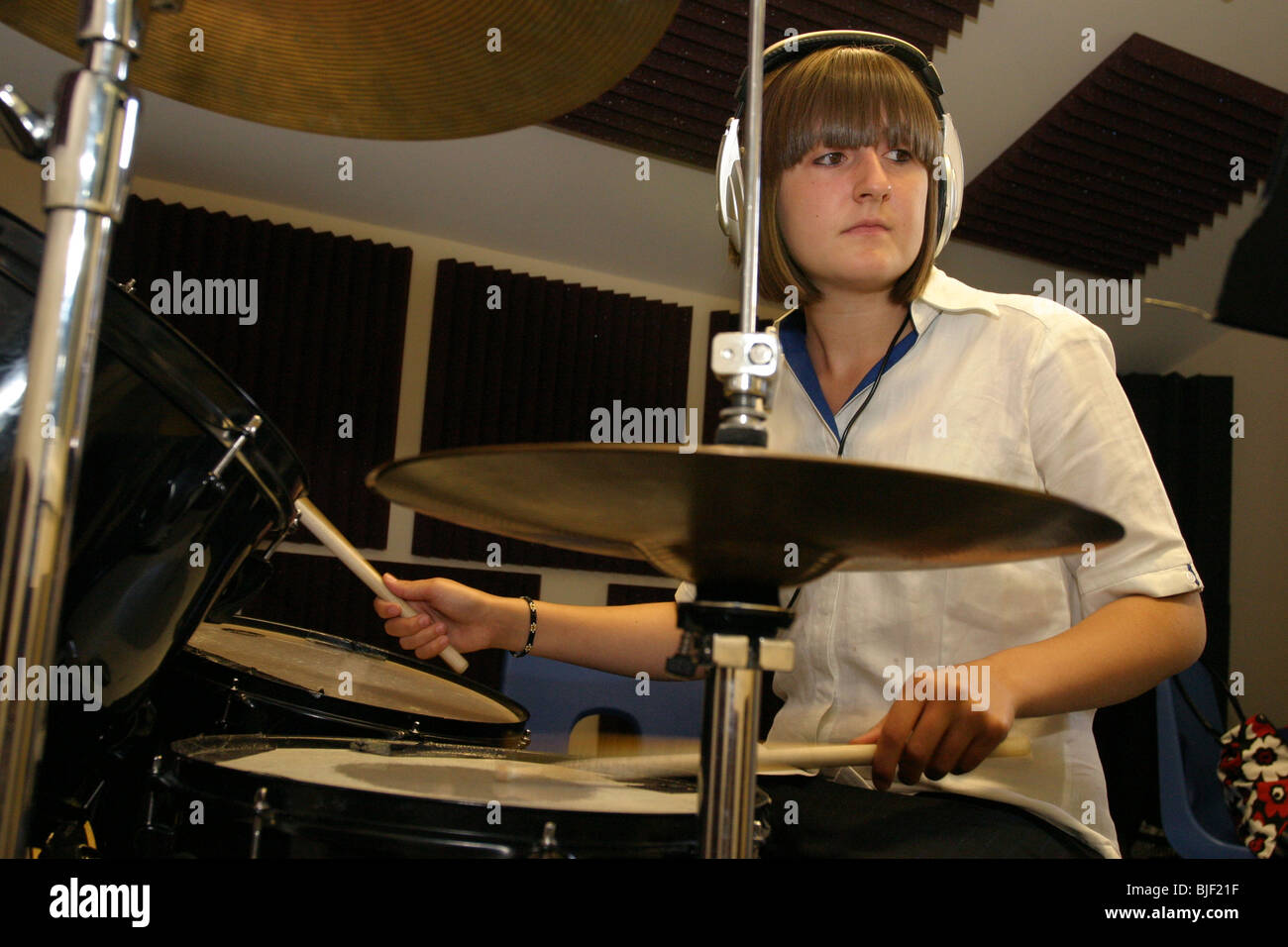 School girl playing drums and cymbals in music lesson Stock Photo - Alamy