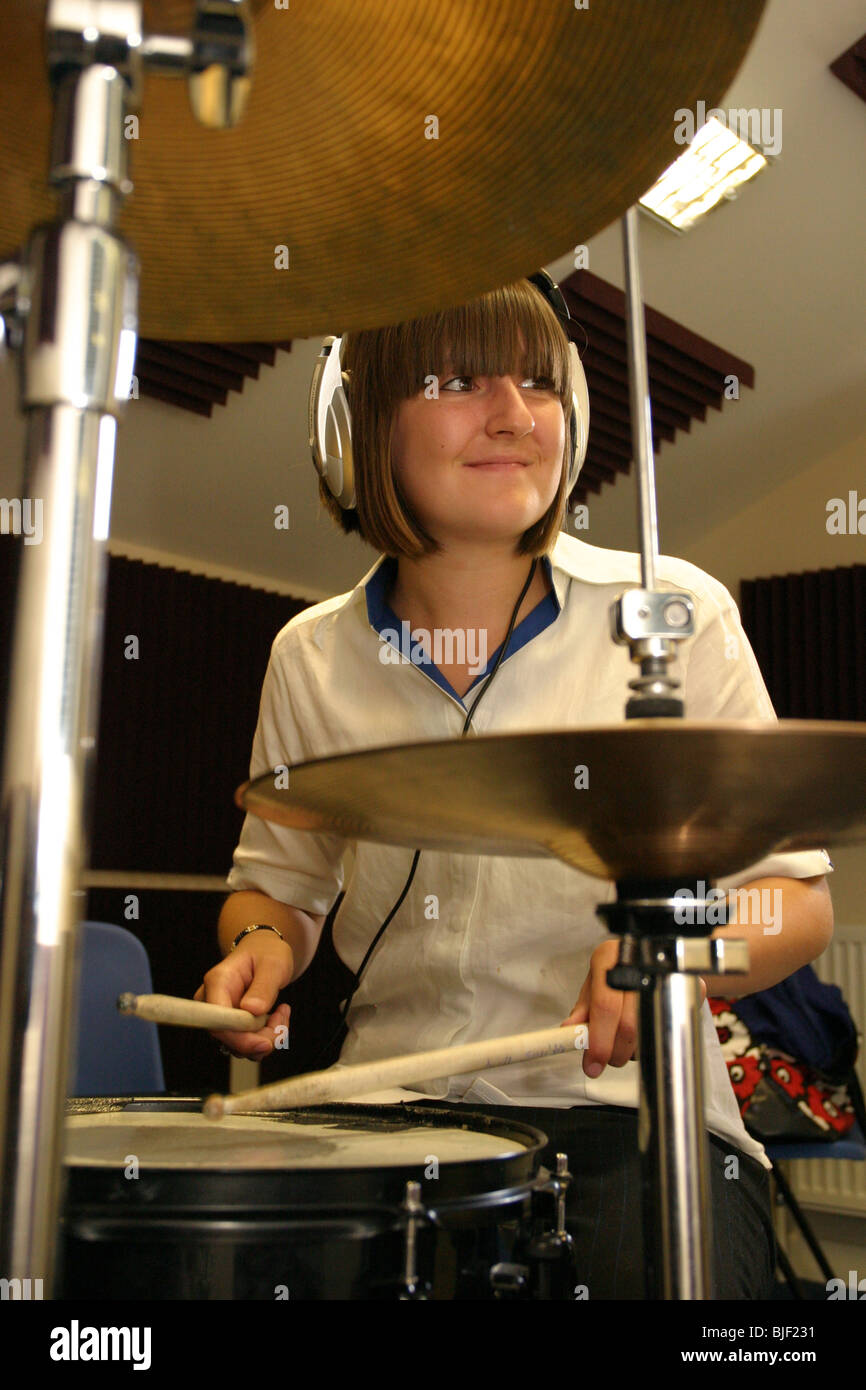 School girl playing drums and cymbals in music lesson Stock Photo - Alamy