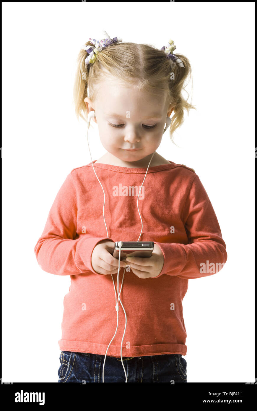 little girl listening to mp3 player Stock Photo - Alamy
