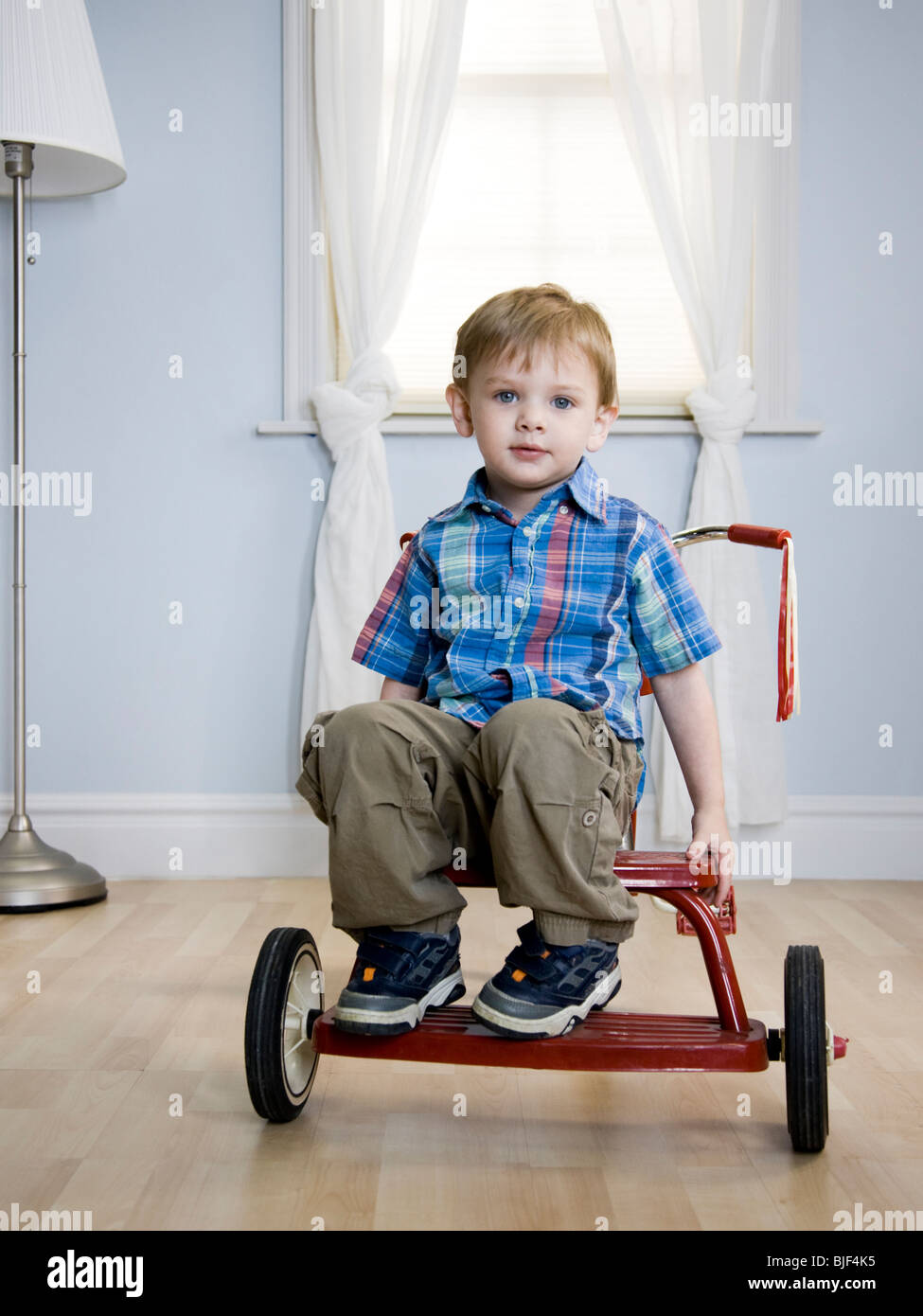 little boy riding a tricycle Stock Photo - Alamy