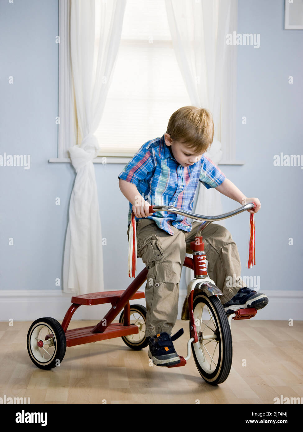 little boy riding a tricycle Stock Photo - Alamy