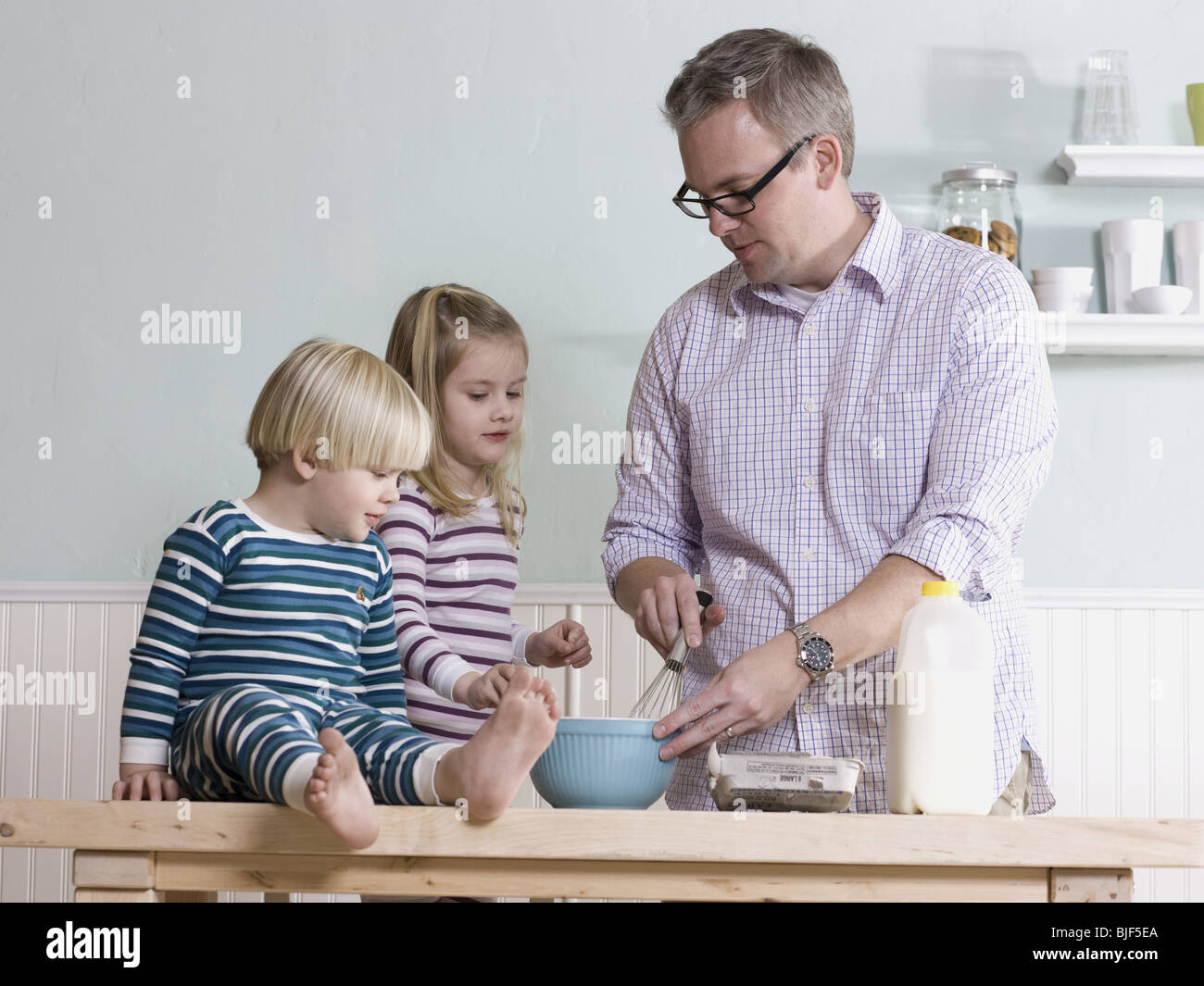 father and children making breakfast Stock Photo - Alamy