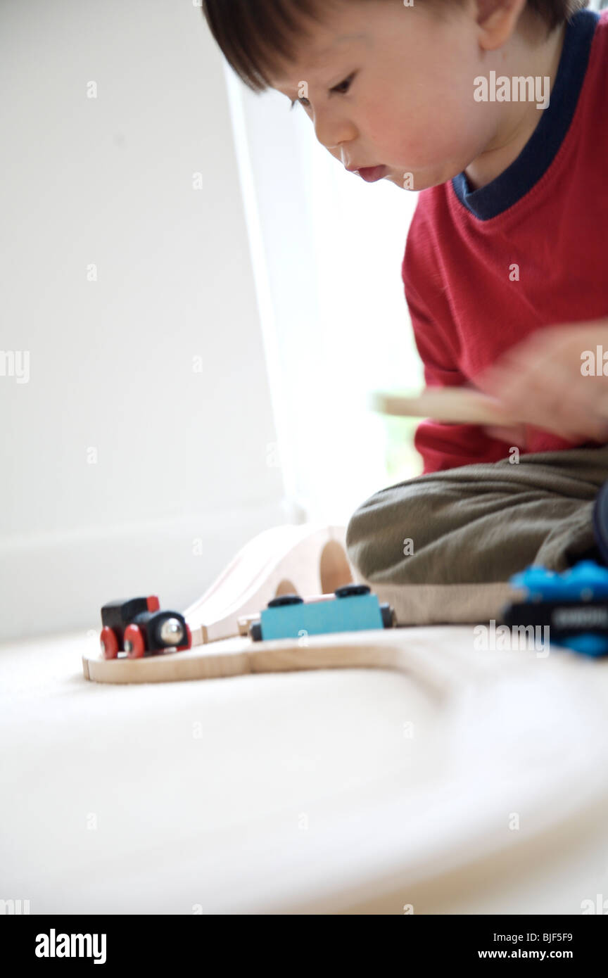 Child playing with wooden train set hi-res stock photography and images ...