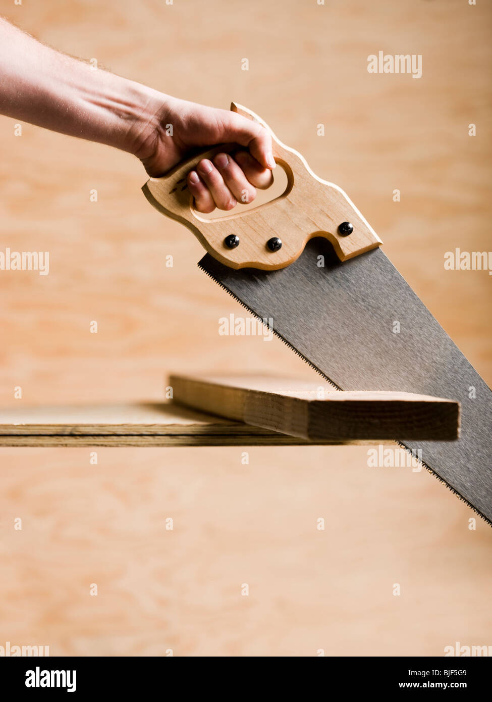 hand sawing a piece of wood Stock Photo - Alamy