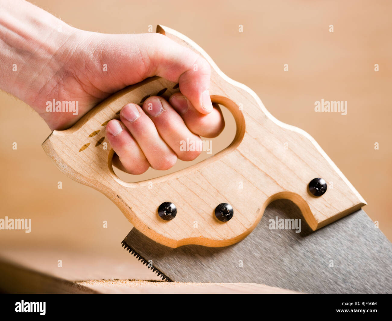 hand sawing a piece of wood Stock Photo - Alamy