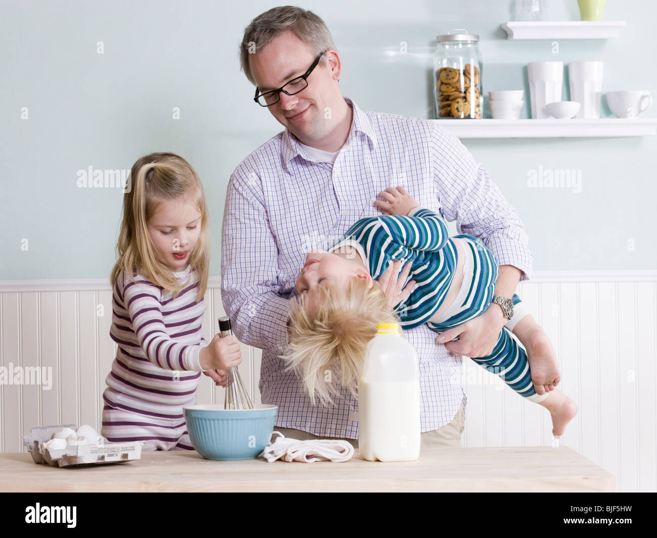 father and children making breakfast Stock Photo - Alamy