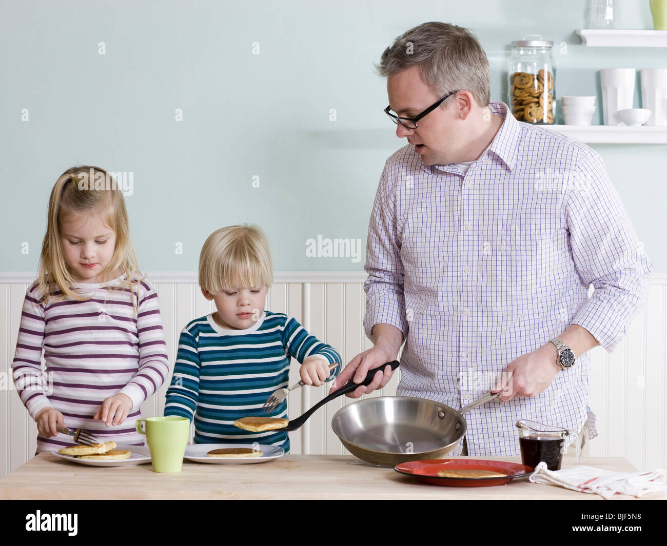 father and children making breakfast Stock Photo - Alamy